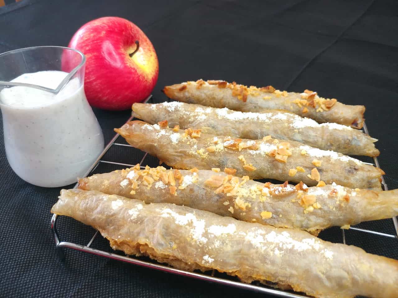 Gluten-free mini apple strudel served with vegan vanilla sauce.